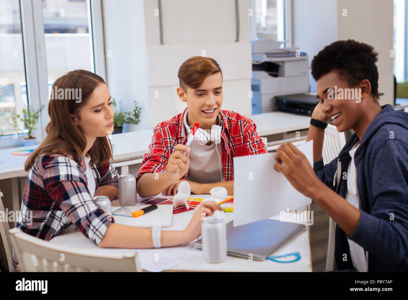 Three postgraduates enjoying the process of studying together Stock ...