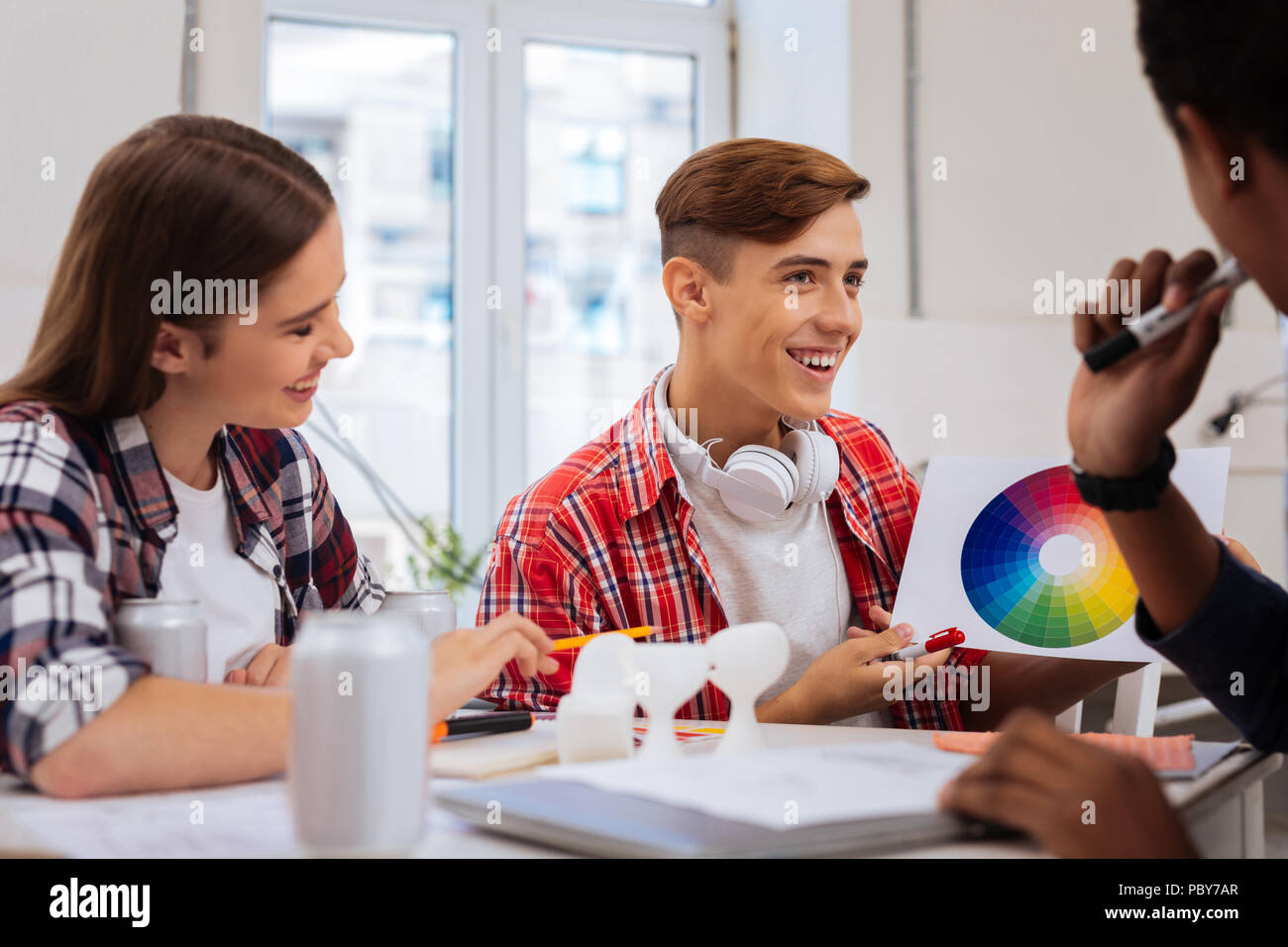 Three young designers looking at color palette Stock Photo - Alamy