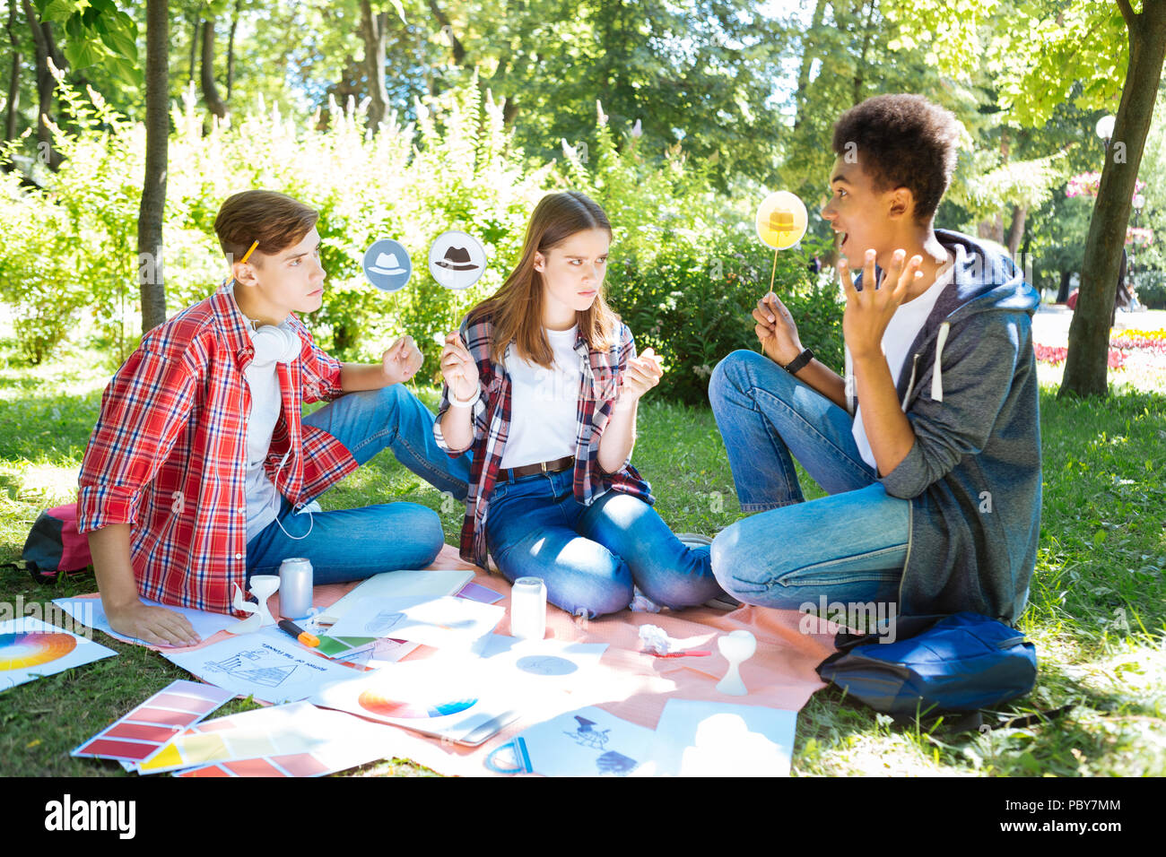 Team of young promising entrepreneurs using thinking hats Stock Photo ...
