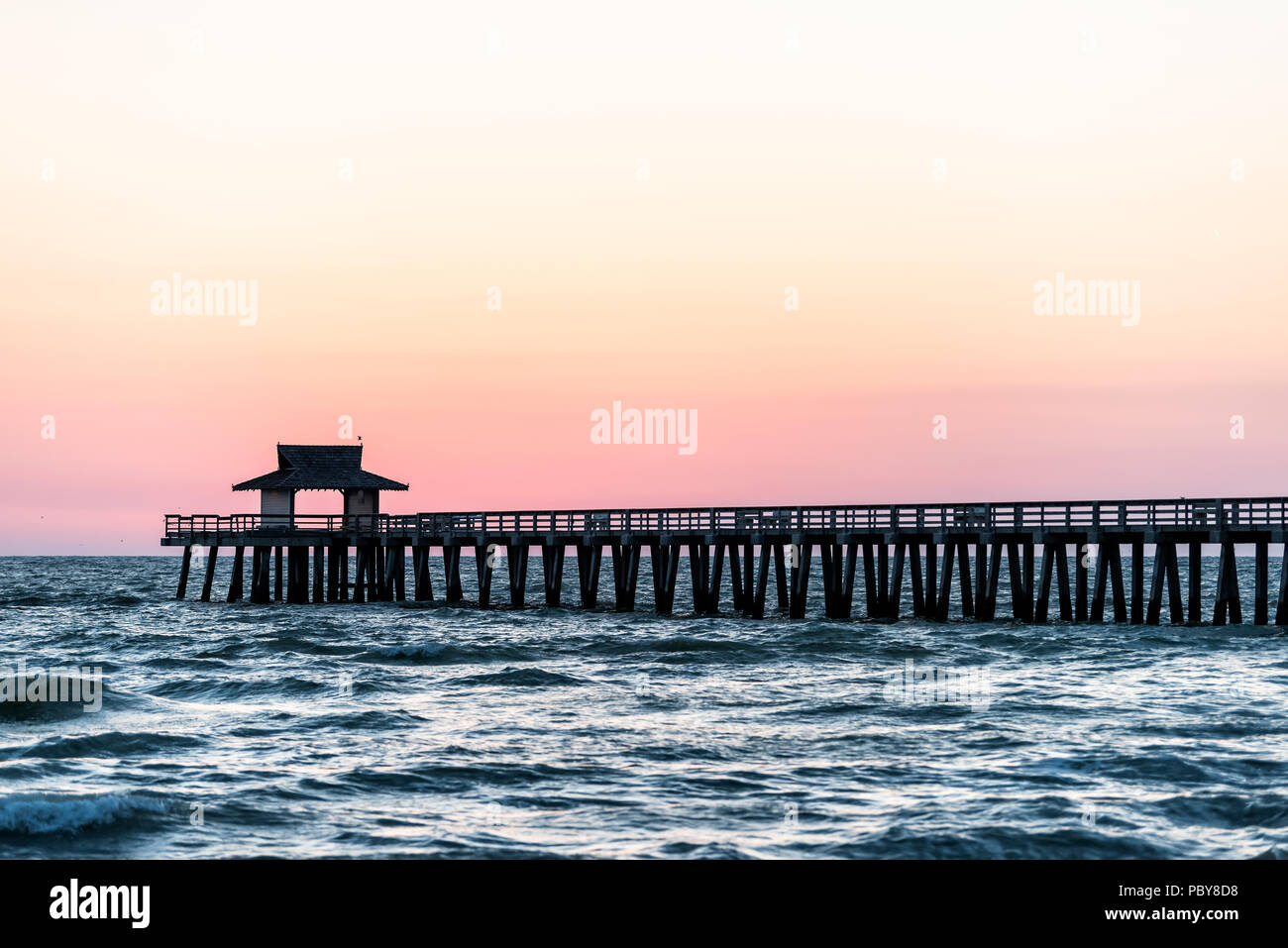 Naples, Florida pink and yellow pastel sunset in gulf of Mexico with ...