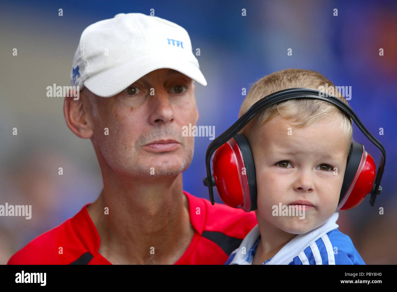 A young fan wearing ear protection in the stands Stock Photo - Alamy