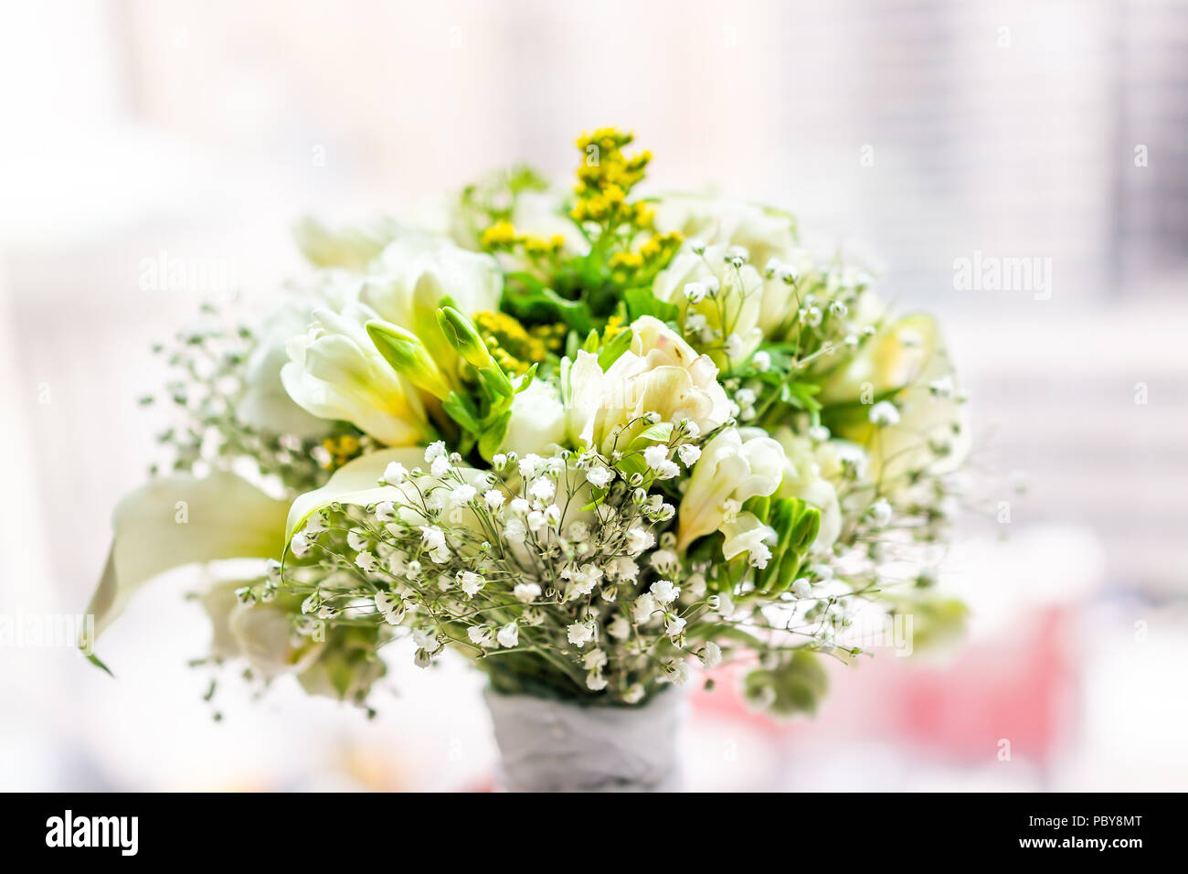 Closeup of flower bouquet in front of bright sunny window in room of ...