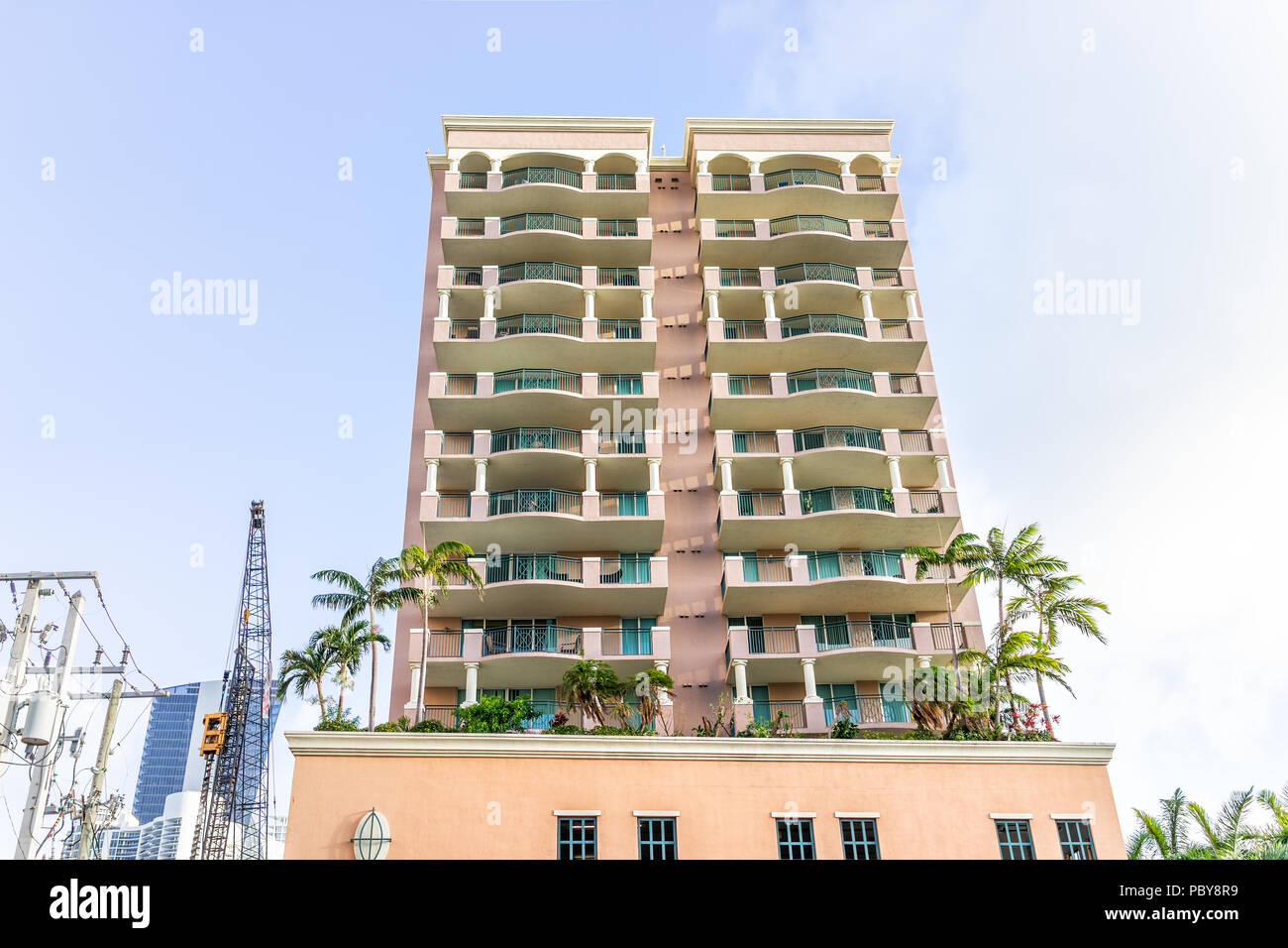 Apartment condo hotel building balconies during sunny day in Miami ...