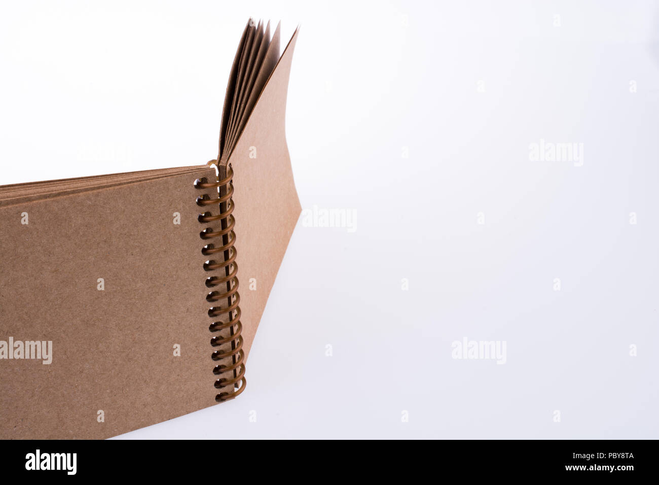 Brown spiral Notebook on a white background Stock Photo - Alamy