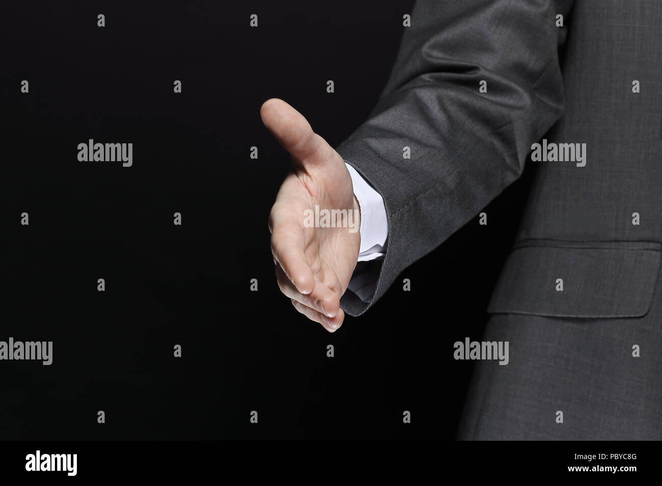 Businessman holding hand out handshake hi-res stock photography and ...