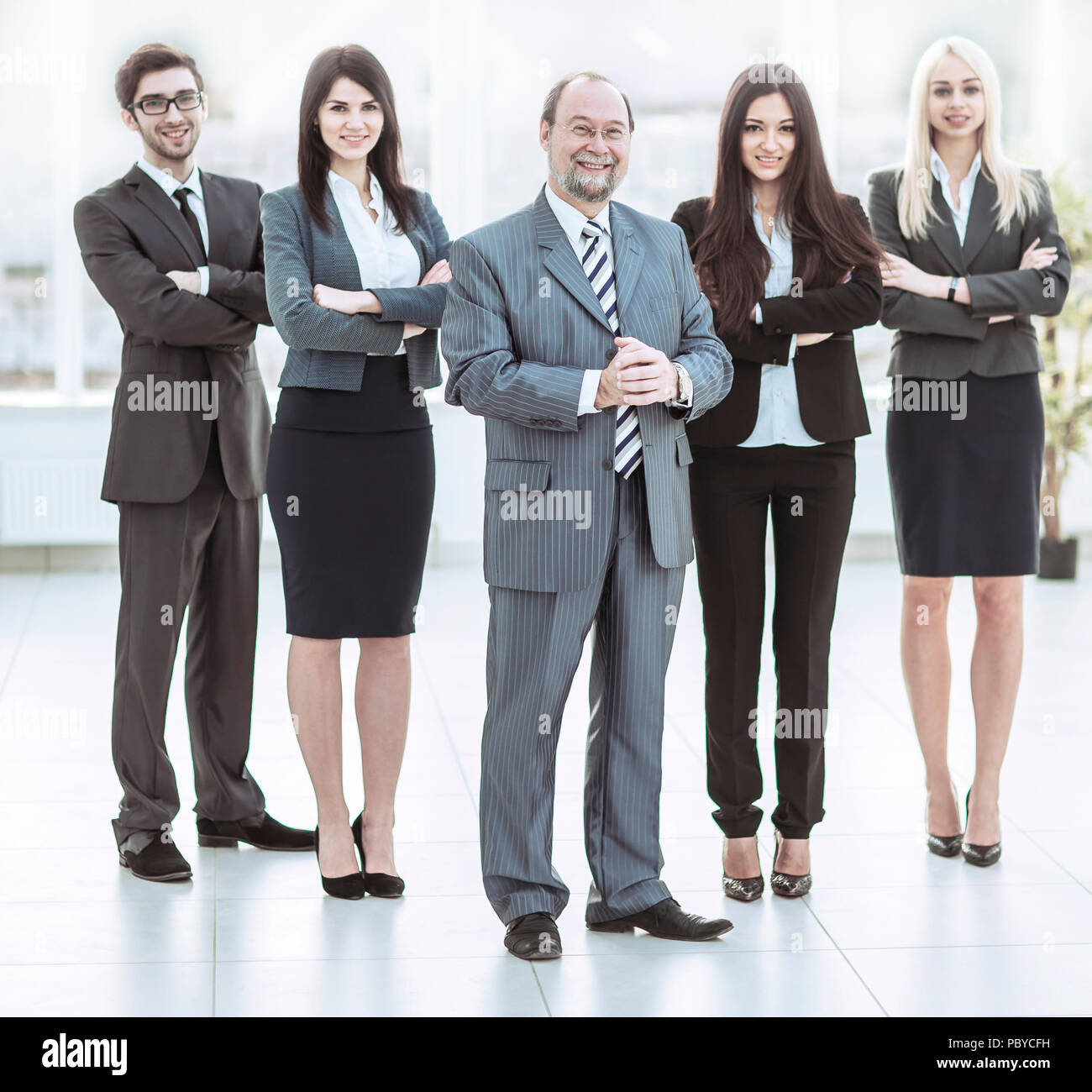 portrait of successful businessman and business team standing together ...