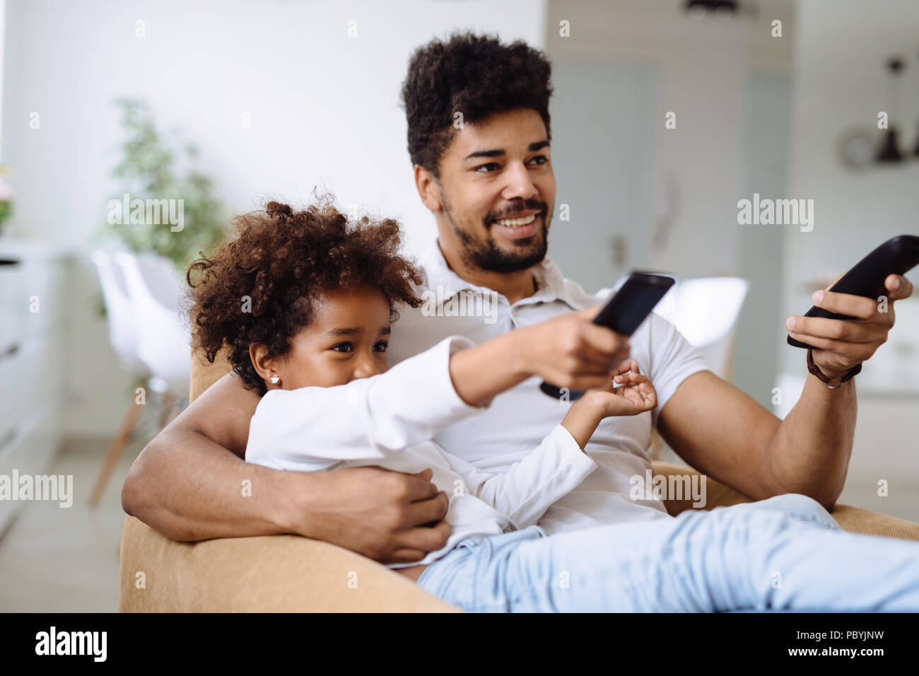 Father And Daughter Watching Television Stock Photo - Alamy