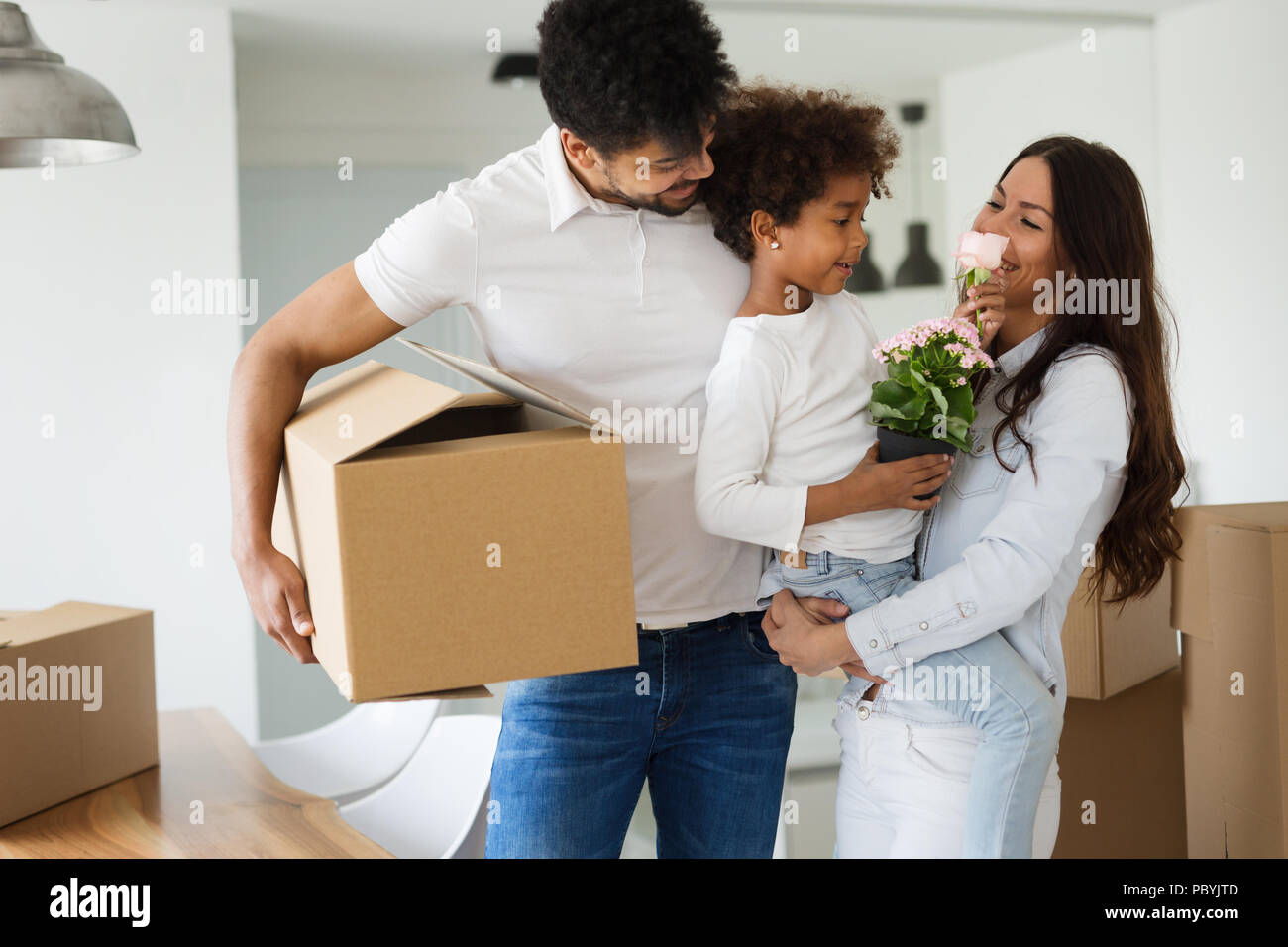 Happy family with cardboard boxes Stock Photo - Alamy