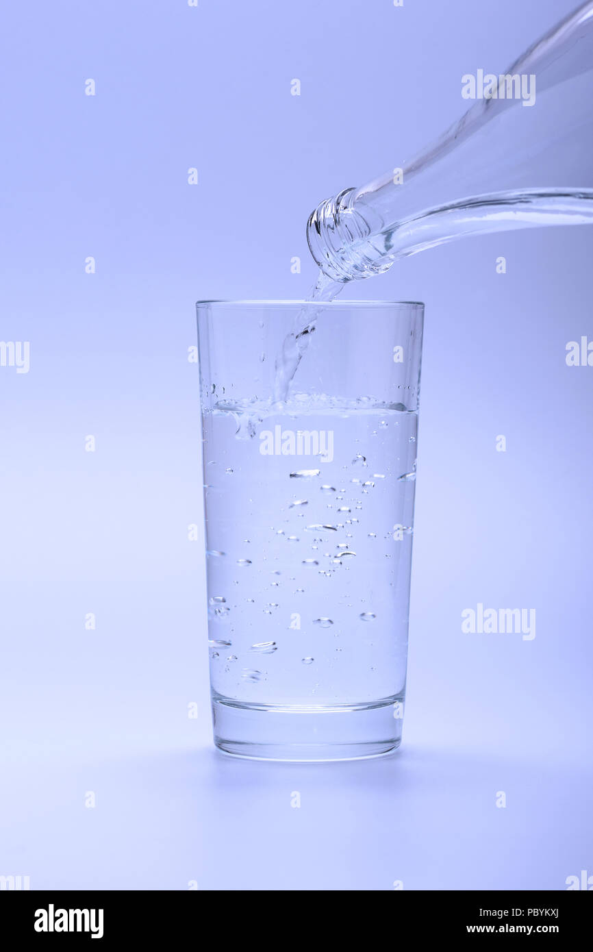 Fresh cold water pouring into a glass from a bottle Stock Photo - Alamy