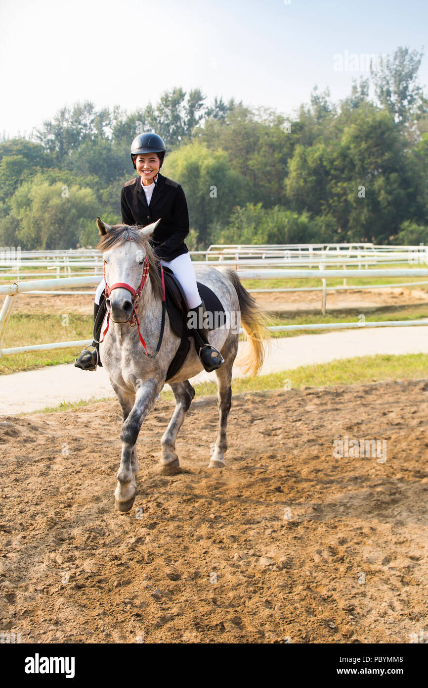 Young chinese woman riding horse hi-res stock photography and images ...