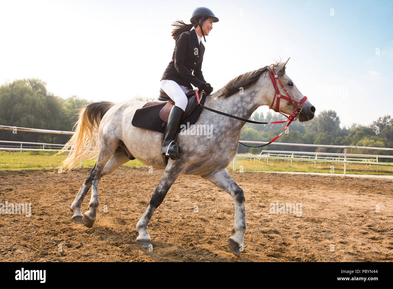 Young chinese woman riding horse hi-res stock photography and images ...