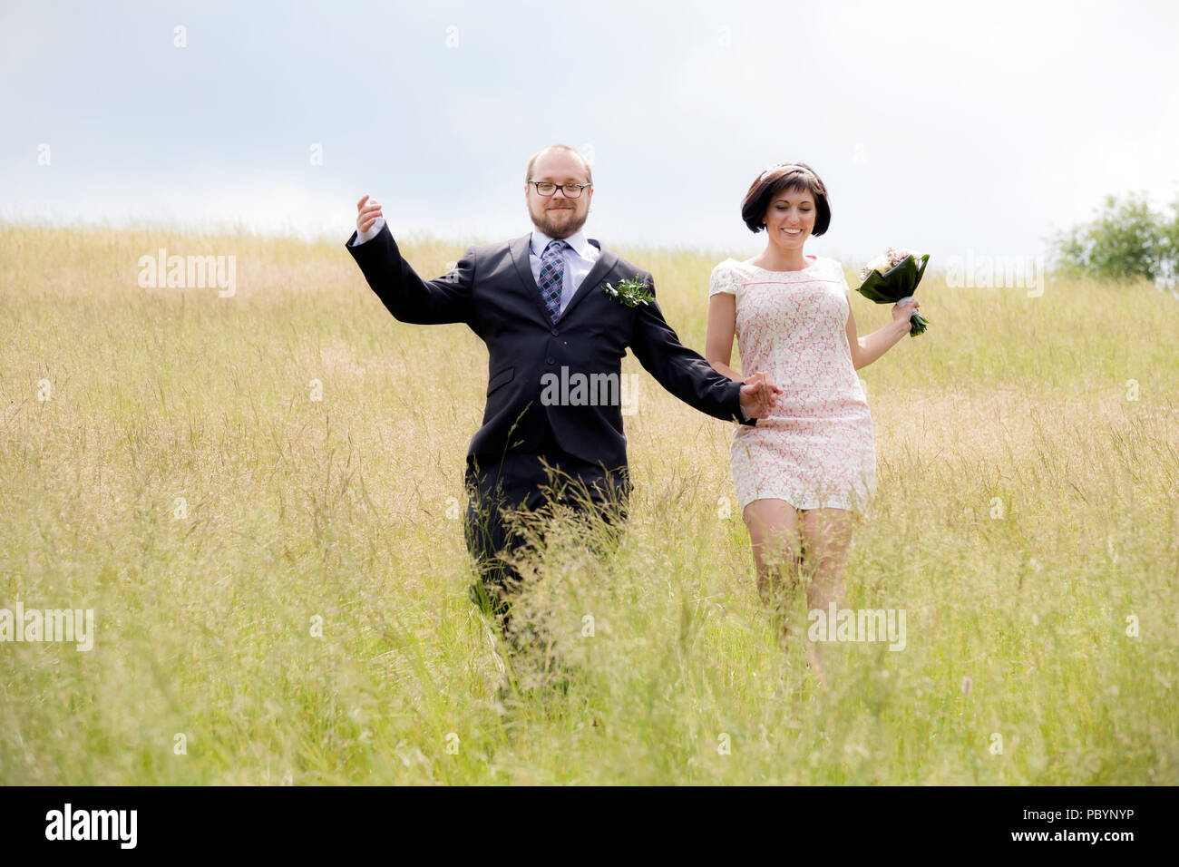 Man and woman running field flowers hi-res stock photography and images ...