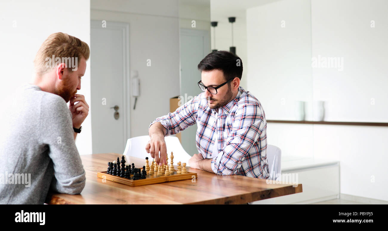 Two young man playing chess Stock Photo - Alamy