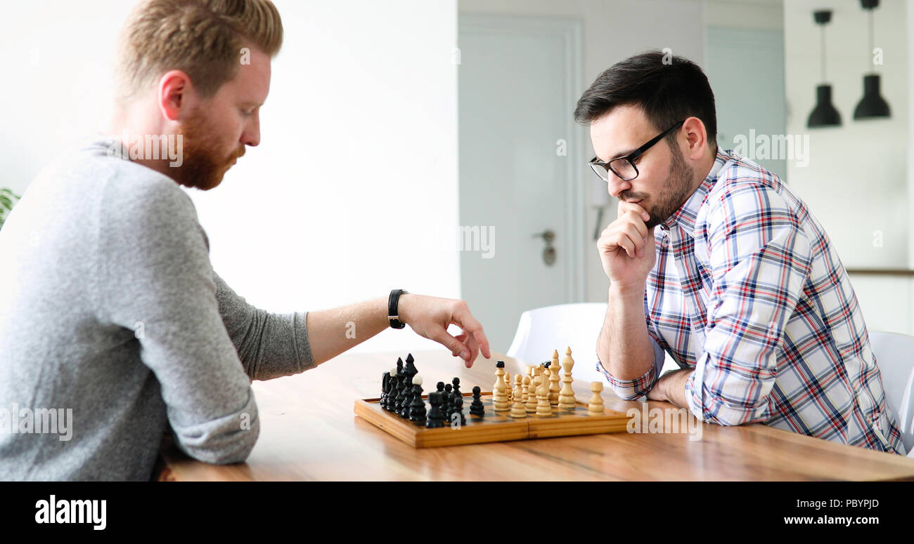 Two young man playing chess Stock Photo - Alamy
