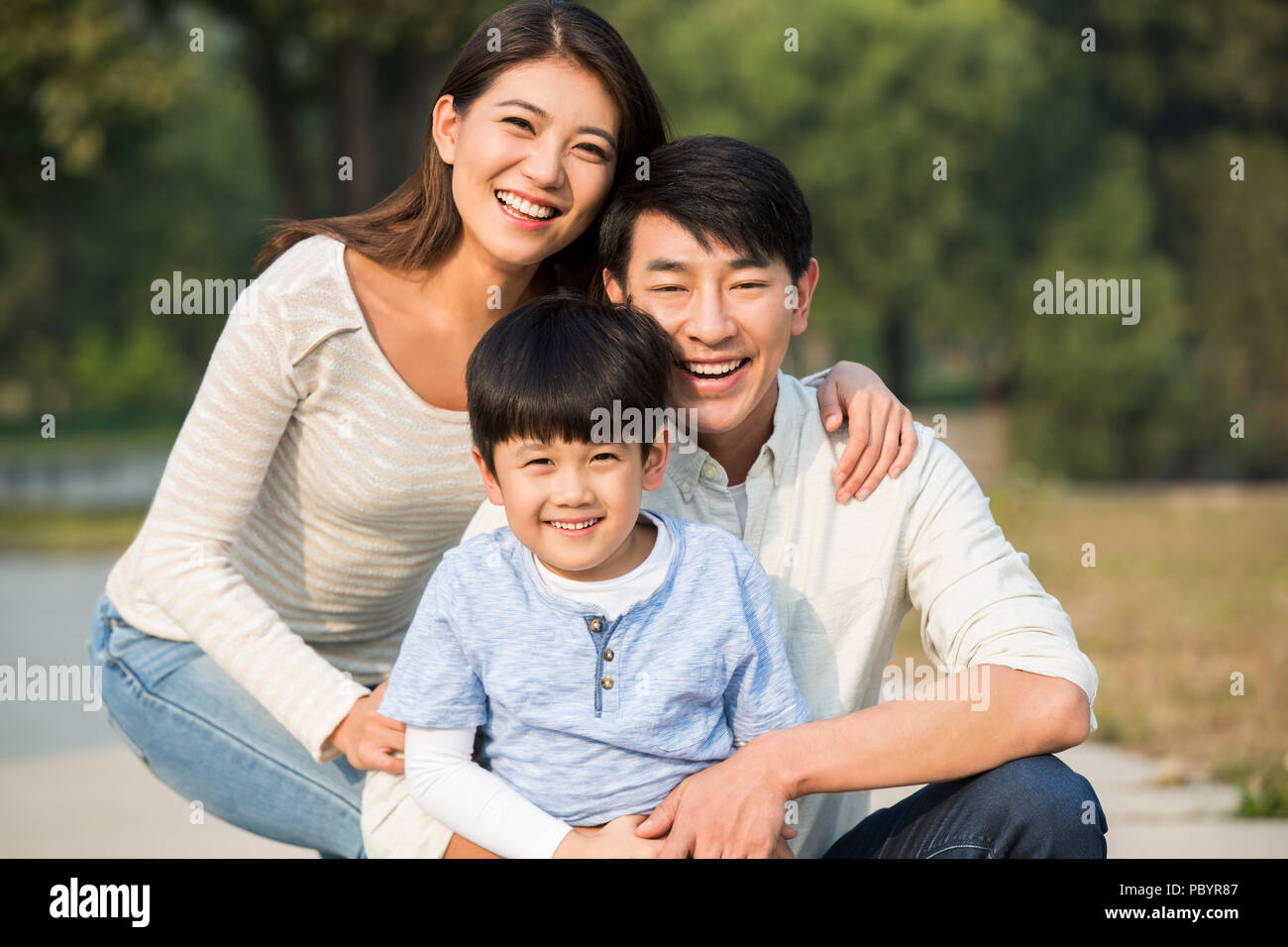 Portrait of cheerful young Chinese family Stock Photo - Alamy