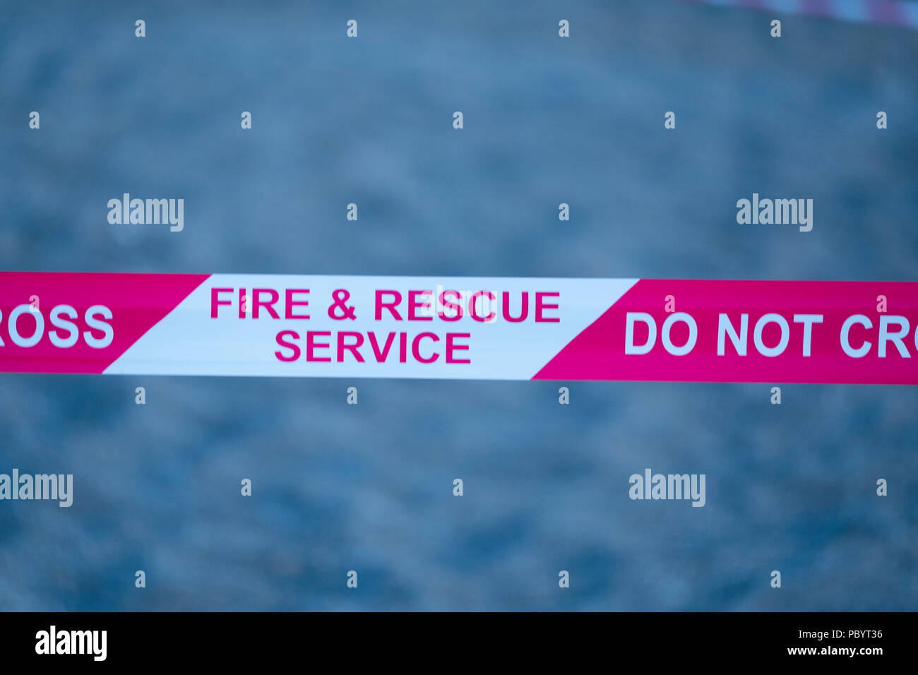 Red and white 999 emergency service Fire and Rescue tape, forming an ...