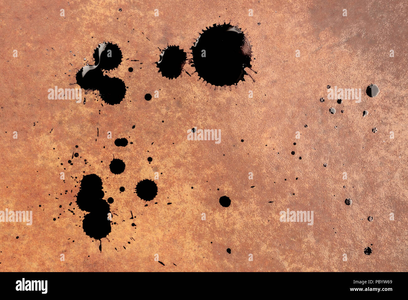 A splash of black ink on a brown texture, a grunge background with copy ...