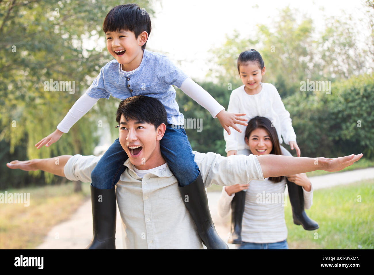 Cheerful young Chinese family playing outdoors Stock Photo - Alamy
