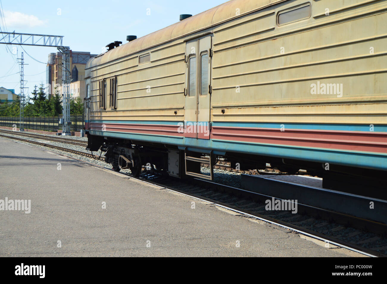 An old Luggage car for transportation of cargo stands on the platform ...