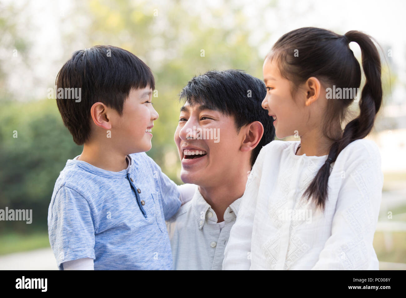 Cheerful young Chinese family playing outdoors Stock Photo - Alamy