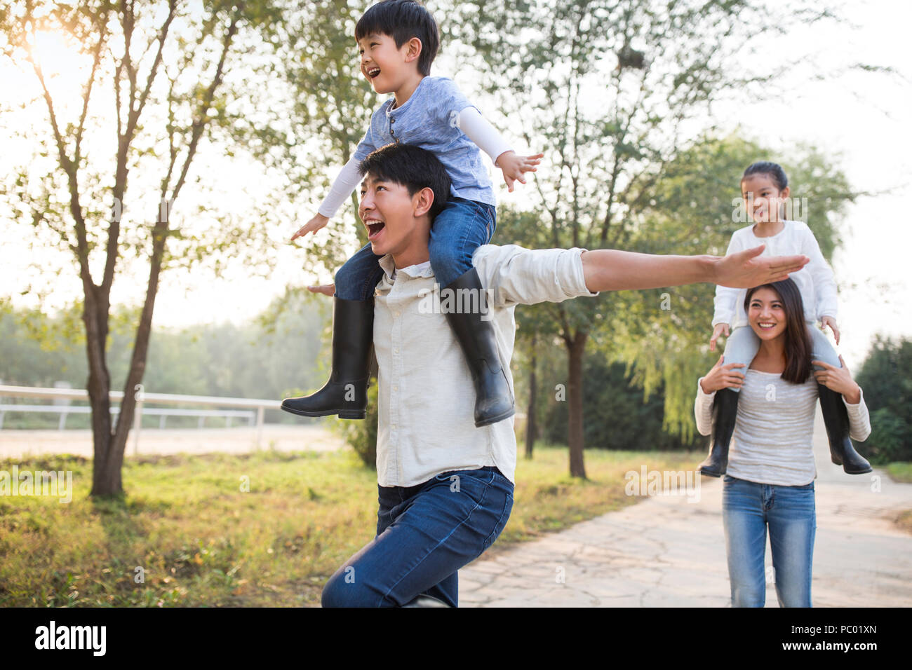 Cheerful young Chinese family playing outdoors Stock Photo - Alamy
