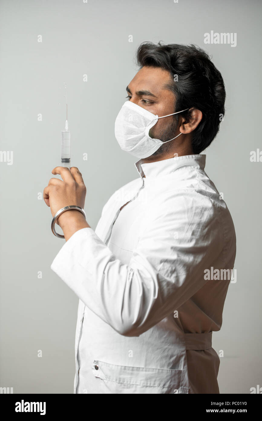 treatment concept. man curing sick people. look at the syringe. close ...