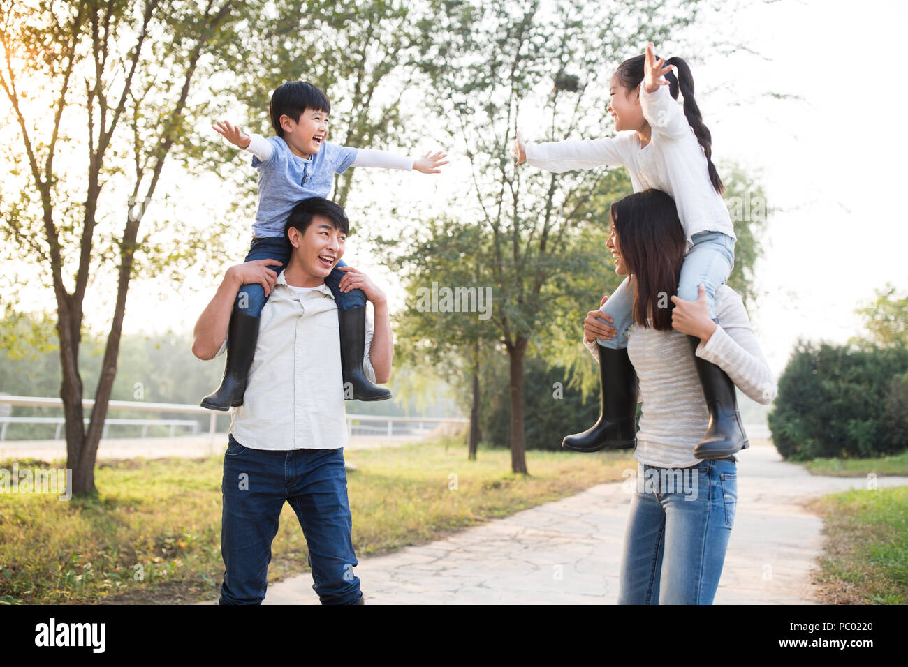 Cheerful young Chinese family playing outdoors Stock Photo - Alamy