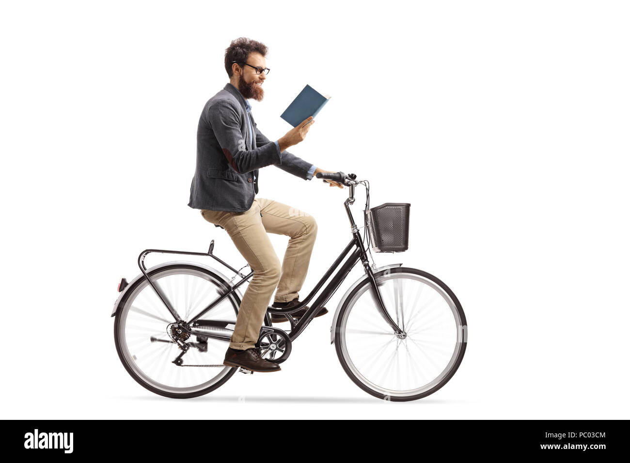 Young man riding a bicycle and reading a book isolated on white ...