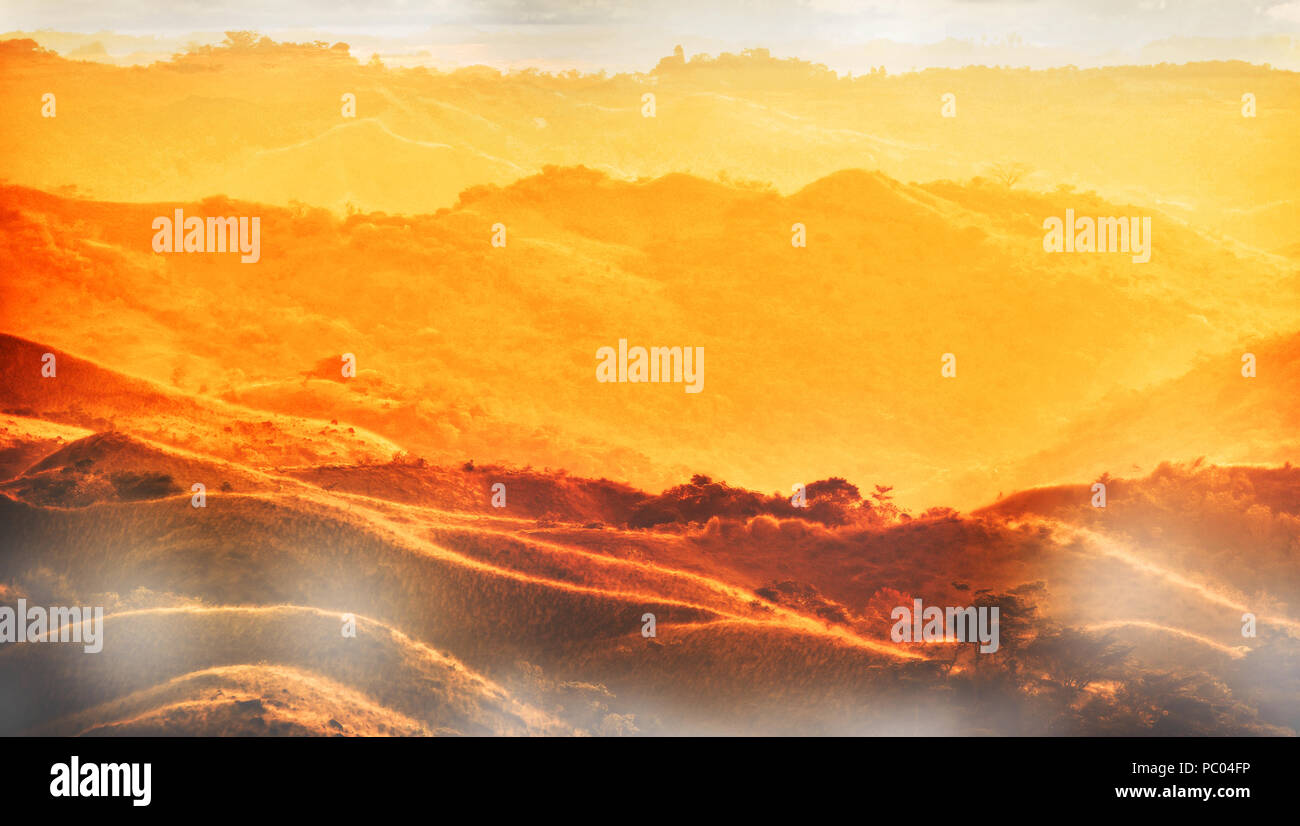 Beautiful sunrise over hills in a foggy morning Stock Photo - Alamy