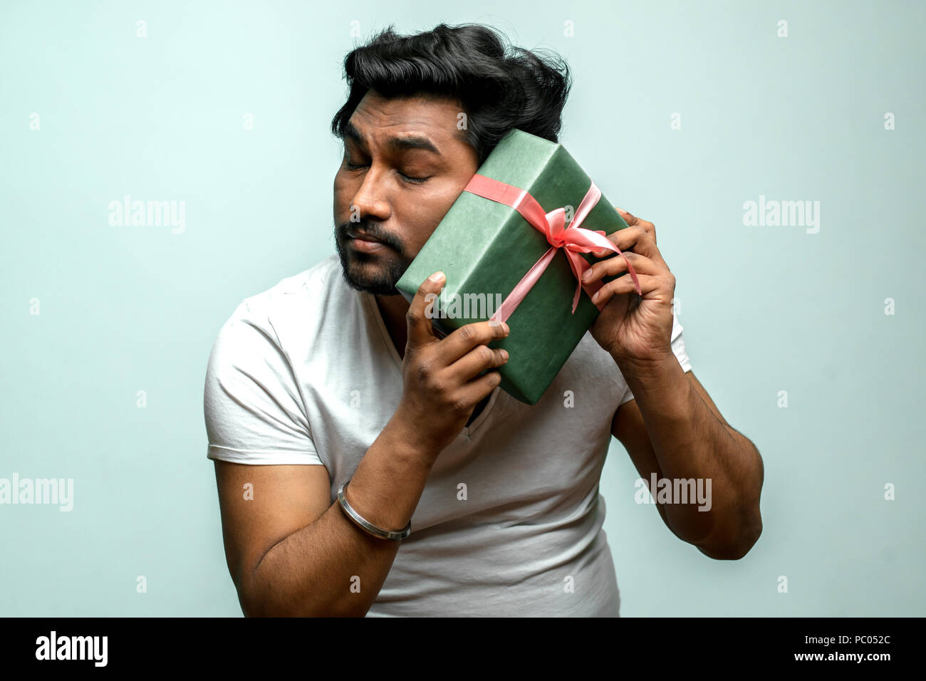 close up photo. sentimental strong Indian guy trying to imagine what he ...