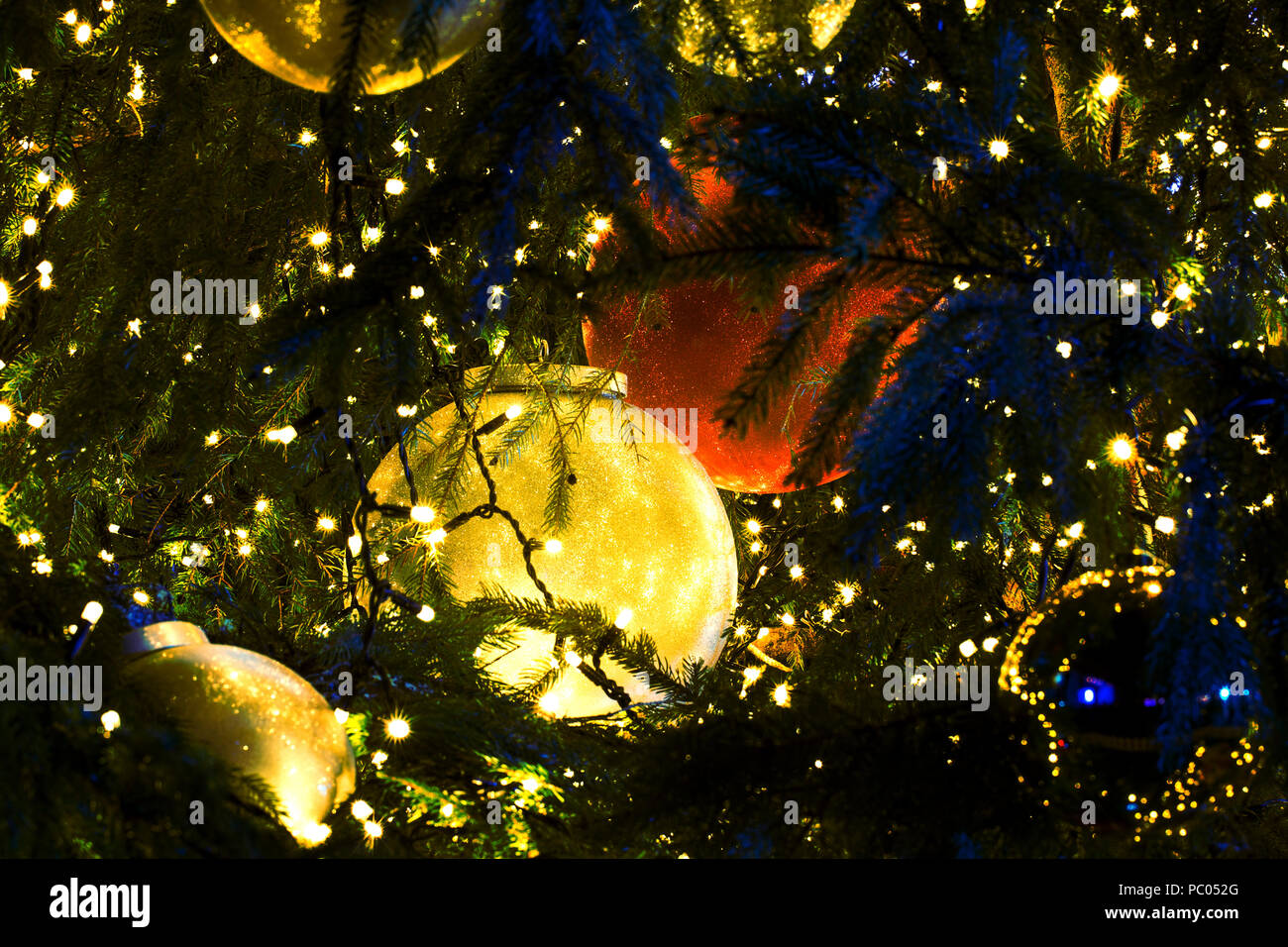 Christmas tree decorated with red and gold balls and garlands ...