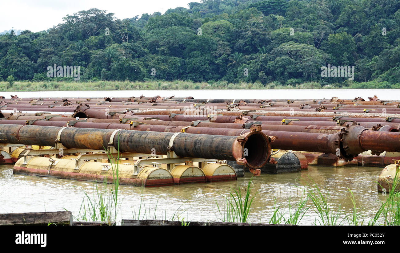 Steel pipe floating on canal waters use to help dredge the Panama Canal ...
