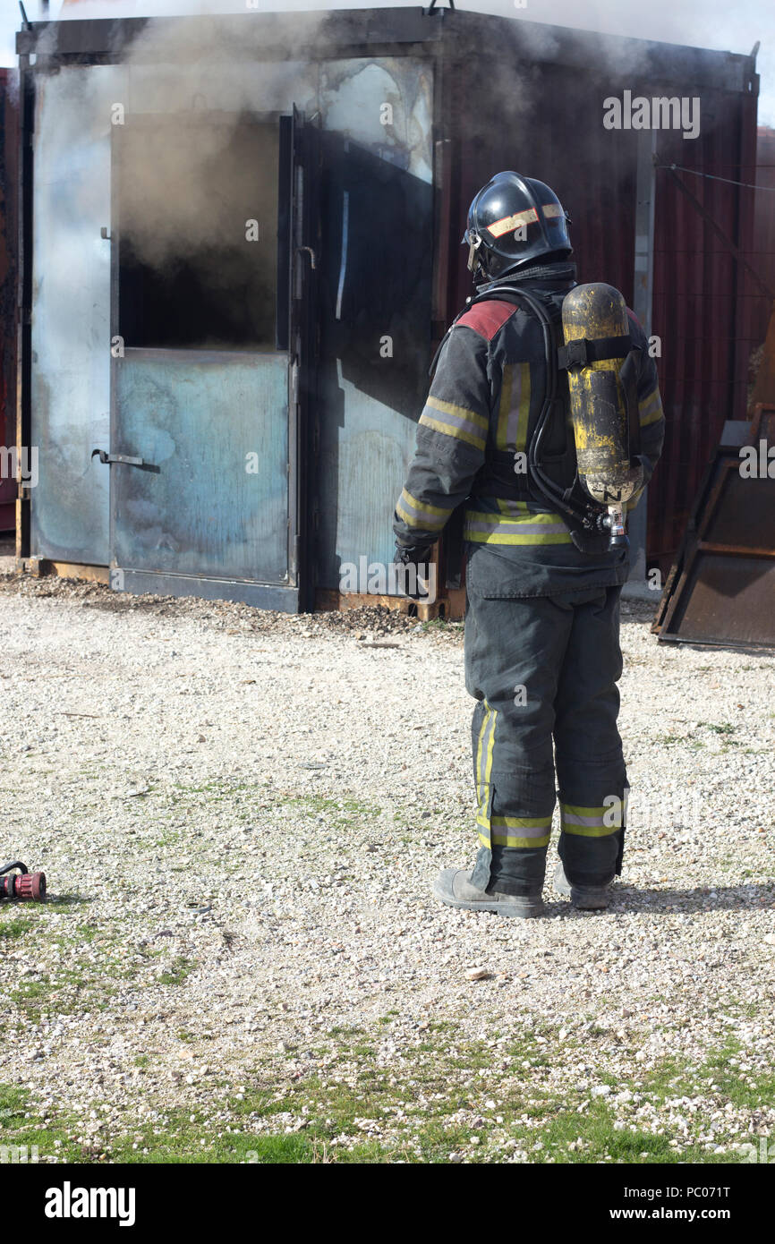 Firefighter putting out fire training station extinguisher backdraft ...