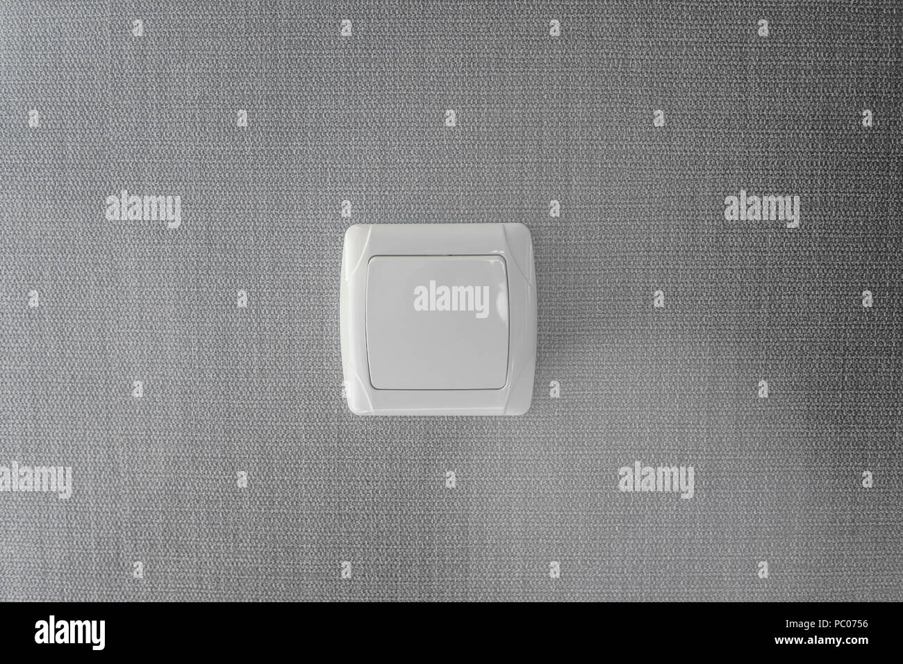 Light switch. Plastic mechanical switch of white color installed on a ...