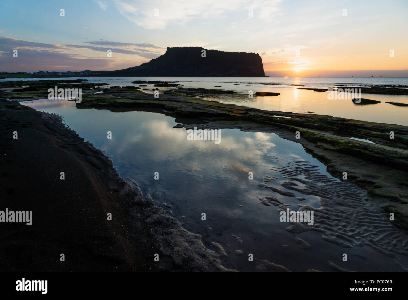 Sunrise out of the clouds at Ilchulbong volcano crater with view over ...