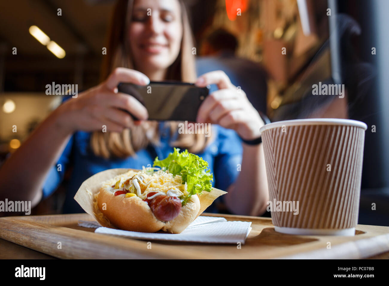 Young woman taking photo of her lunch in cafe Stock Photo - Alamy