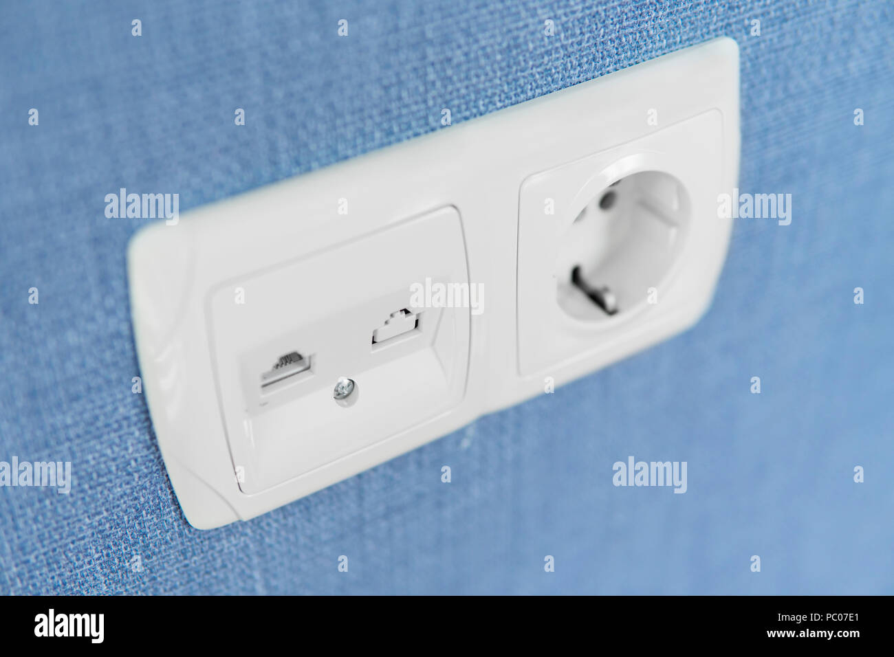 Socket on a blue wall, a multifunction outlet with an internet ...