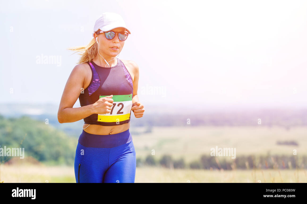 Young slim woman running trail race contest Stock Photo - Alamy