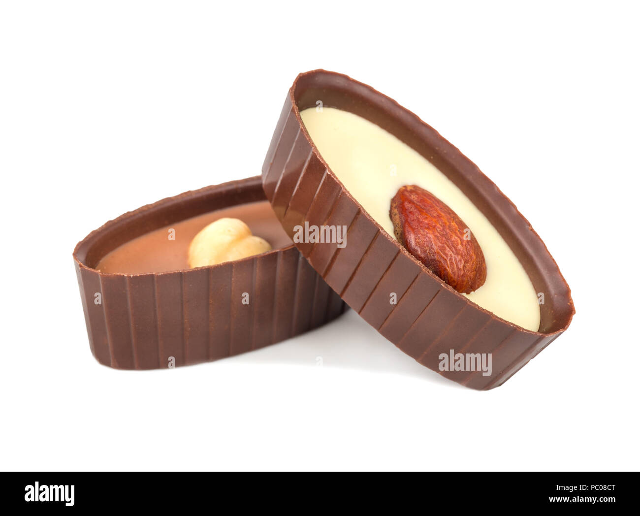 Two chocolates with nuts on white background Stock Photo - Alamy