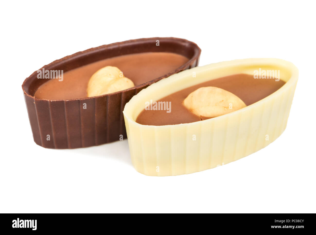 Two chocolates with nuts on white background Stock Photo - Alamy
