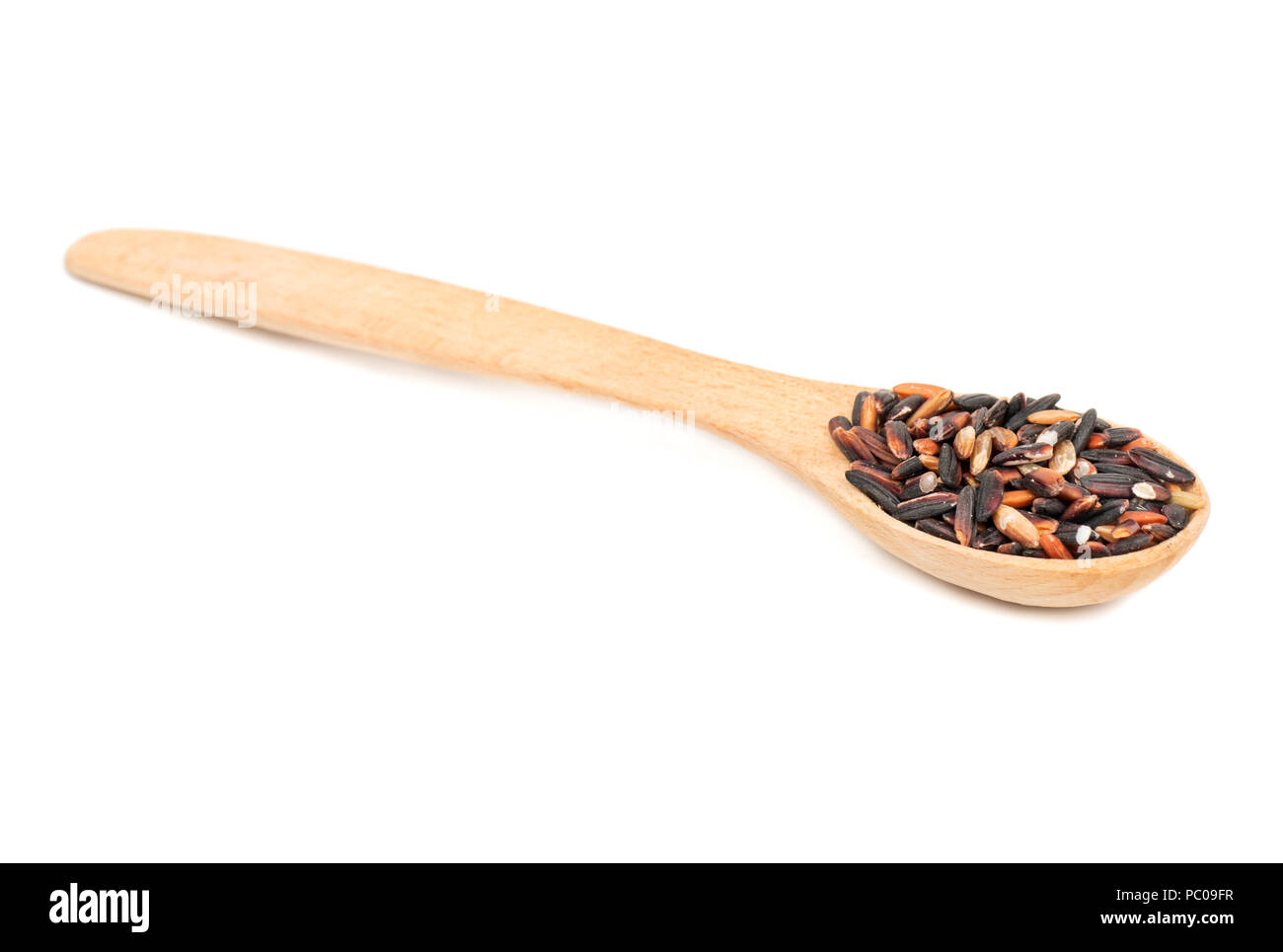 Small wooden spoon with raw black rice isolated on white background ...