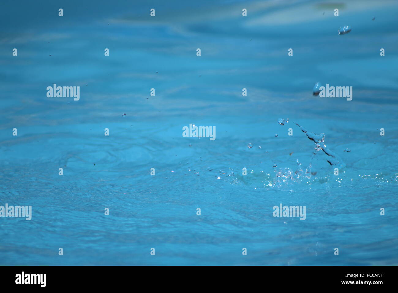 water drops in a blue pool Stock Photo - Alamy