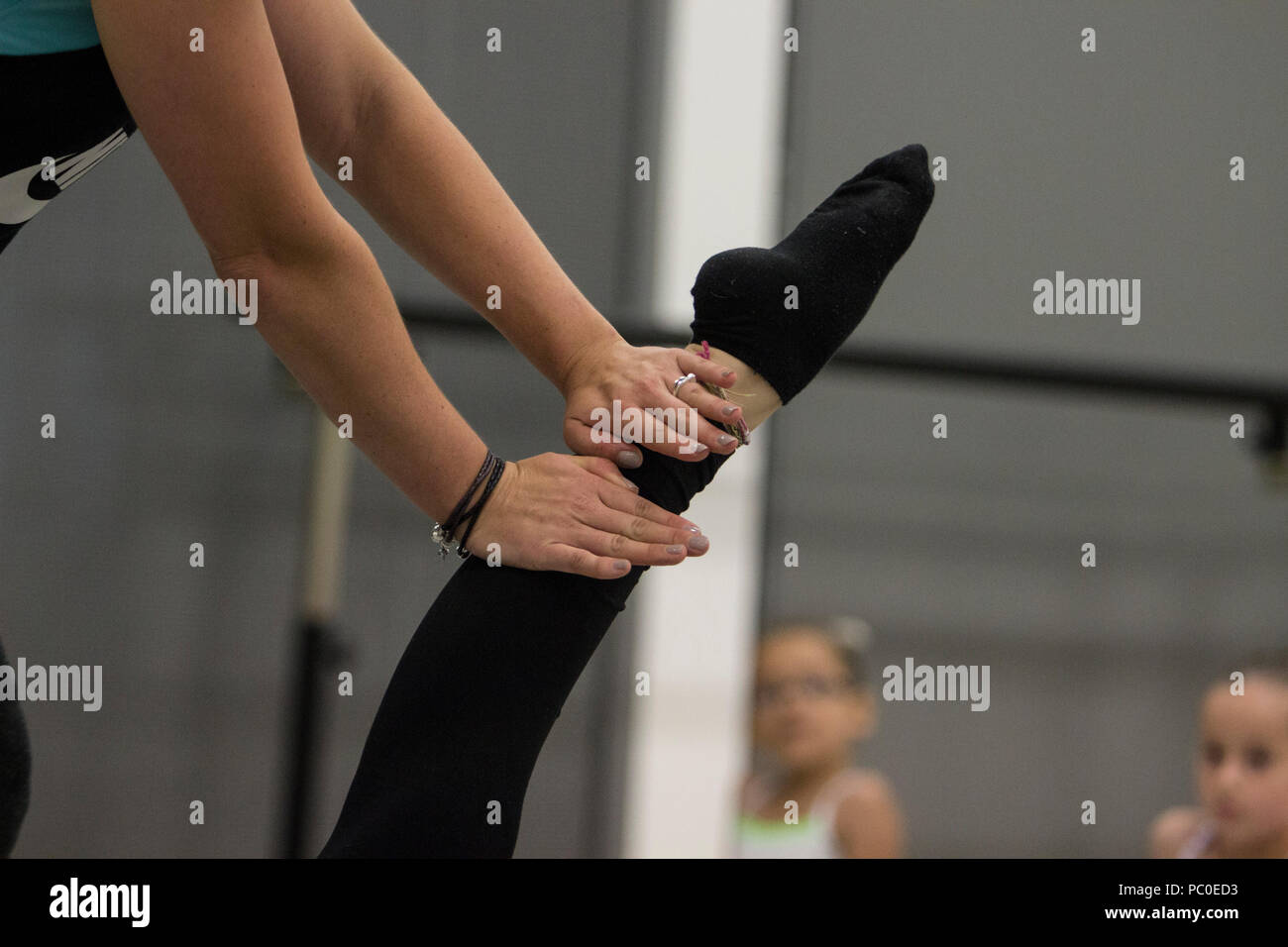 Shot of dancers warming up and stretching ready for a ballet audition ...