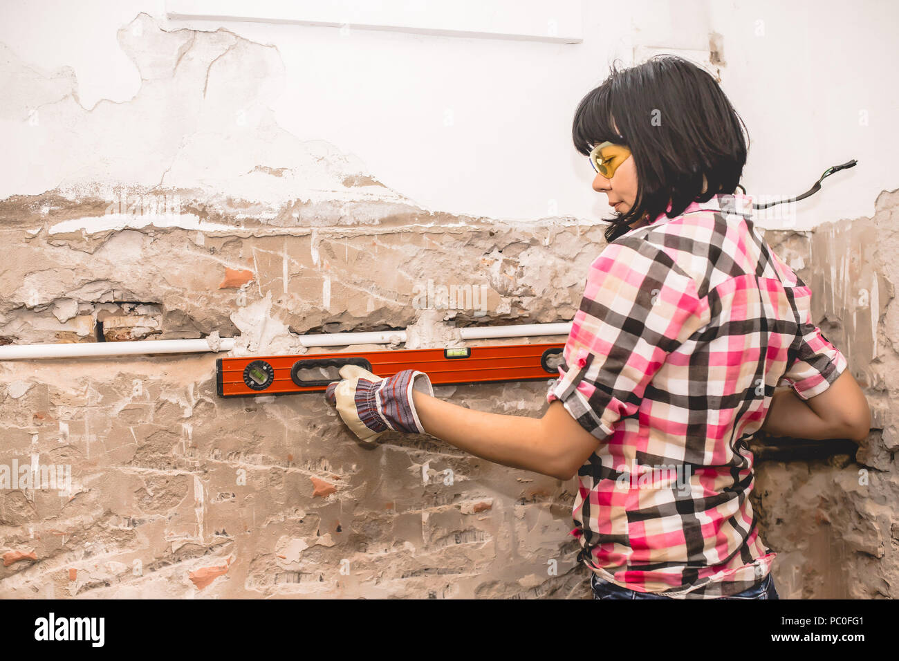 Clever woman repairing her bathroom sink pipe with positive attitude ...