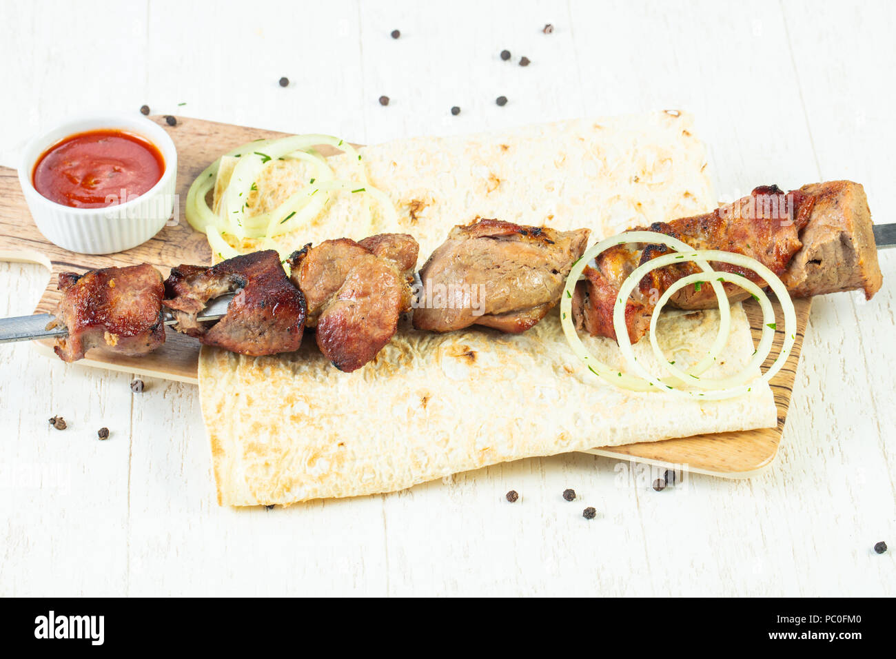 Grilled pork kebab with onion and sauce Stock Photo - Alamy
