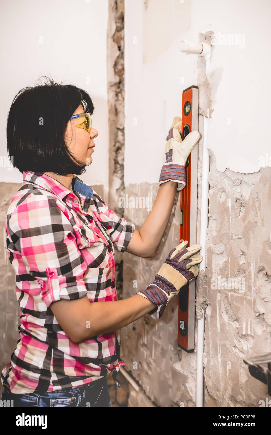 Clever woman repairing her bathroom sink pipe with positive attitude ...