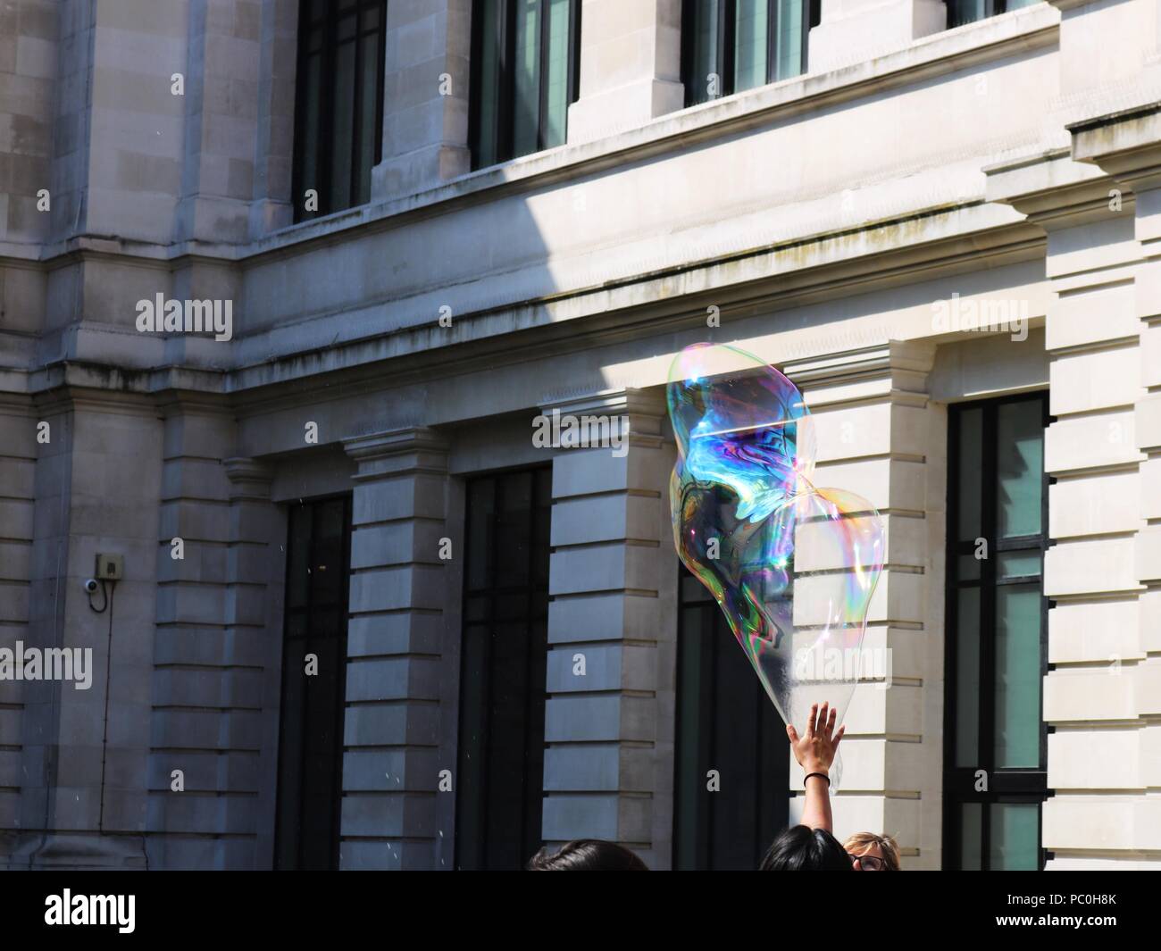 Hand grabbing for giant bubble Stock Photo - Alamy