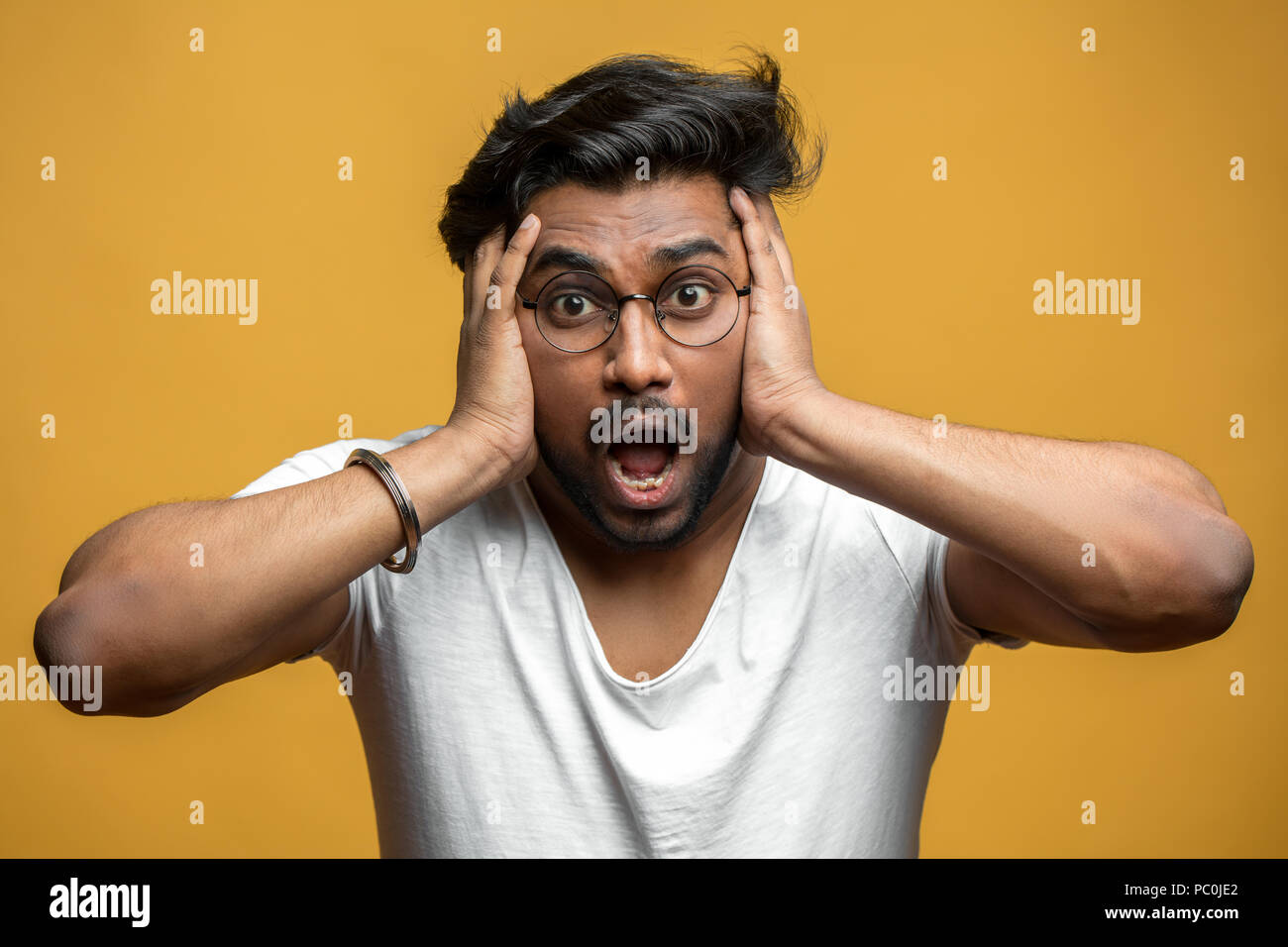 Indian handsome guy expressing shock and despair, touching his head ...