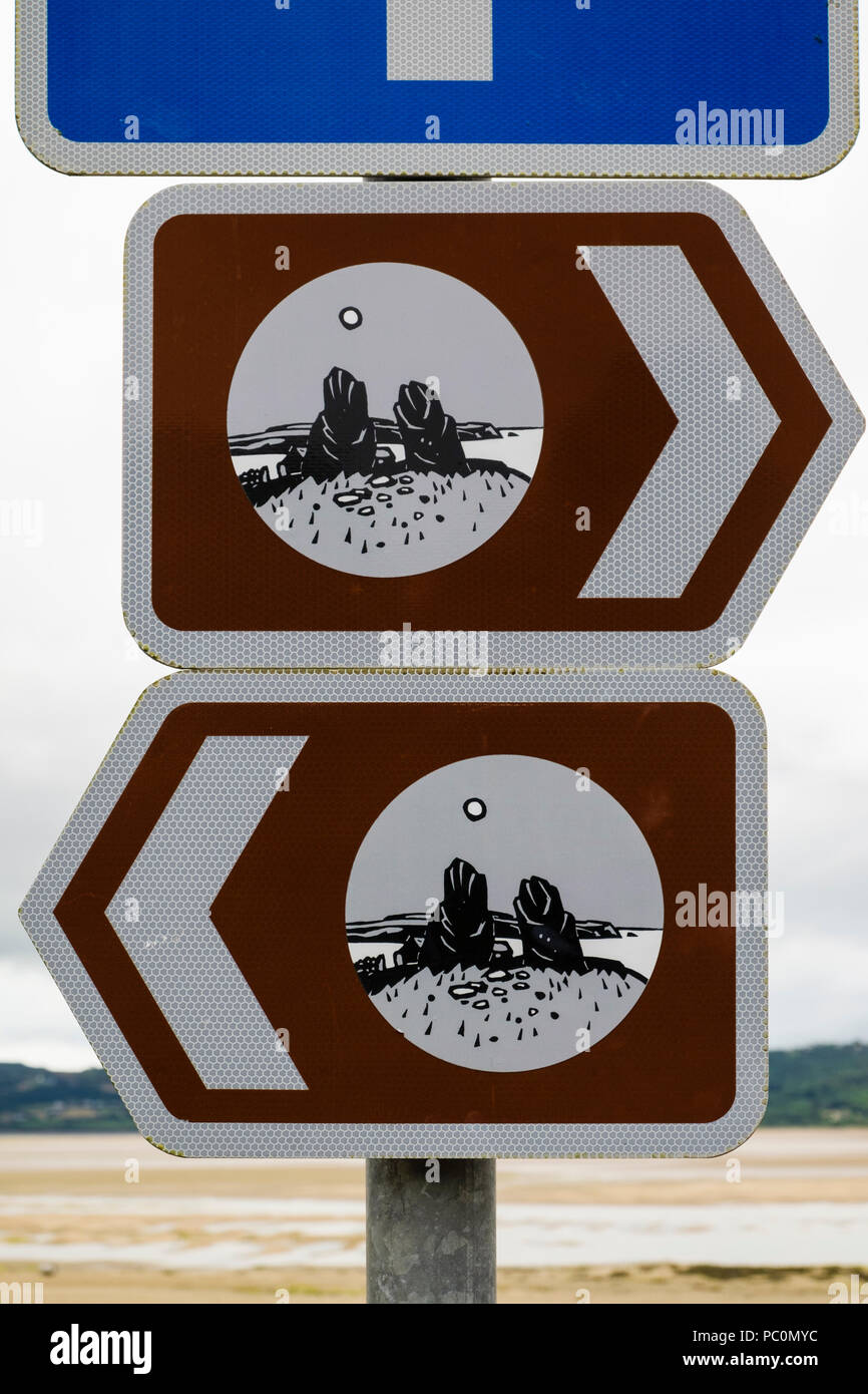 Brown signs pointing each way beside sands at Red Wharf Bay (Traeth ...