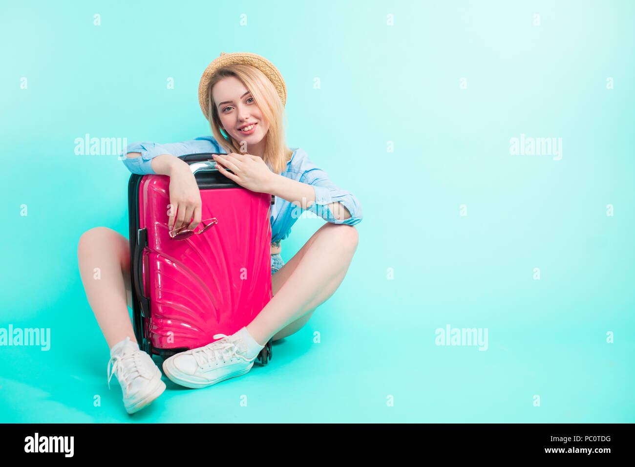 good-looking student with pink suitcase. copyspace. pleasure from the ...